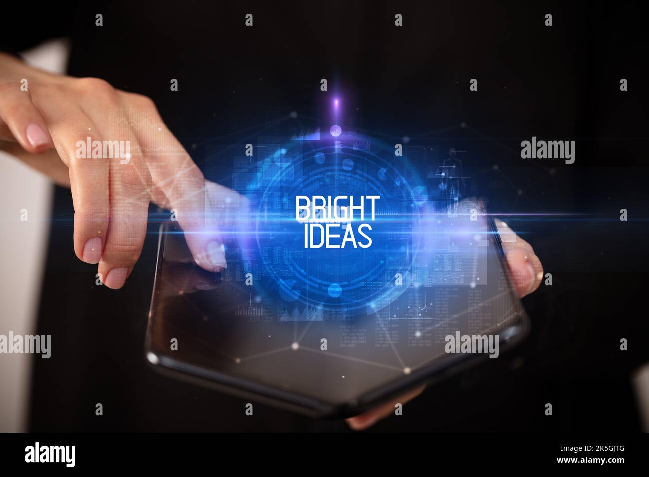 Young man holding a foldable smartphone Stock Photo - Alamy