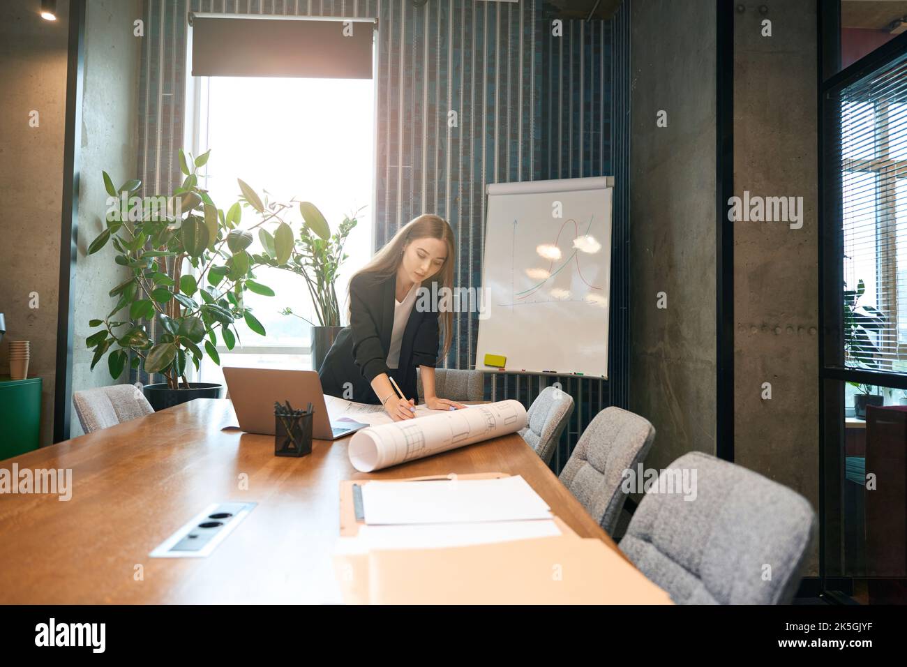 Experienced young female architect drafting floor plan Stock Photo - Alamy