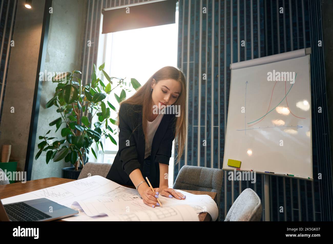 Experienced draftswoman concentrated on creating technical drawing ...