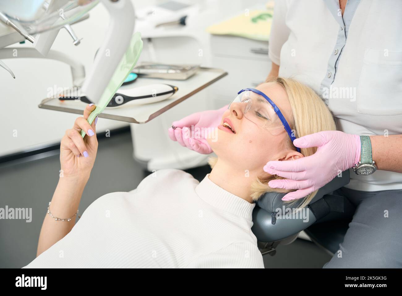 Doctor examining teeth medical instruments hi-res stock photography and ...