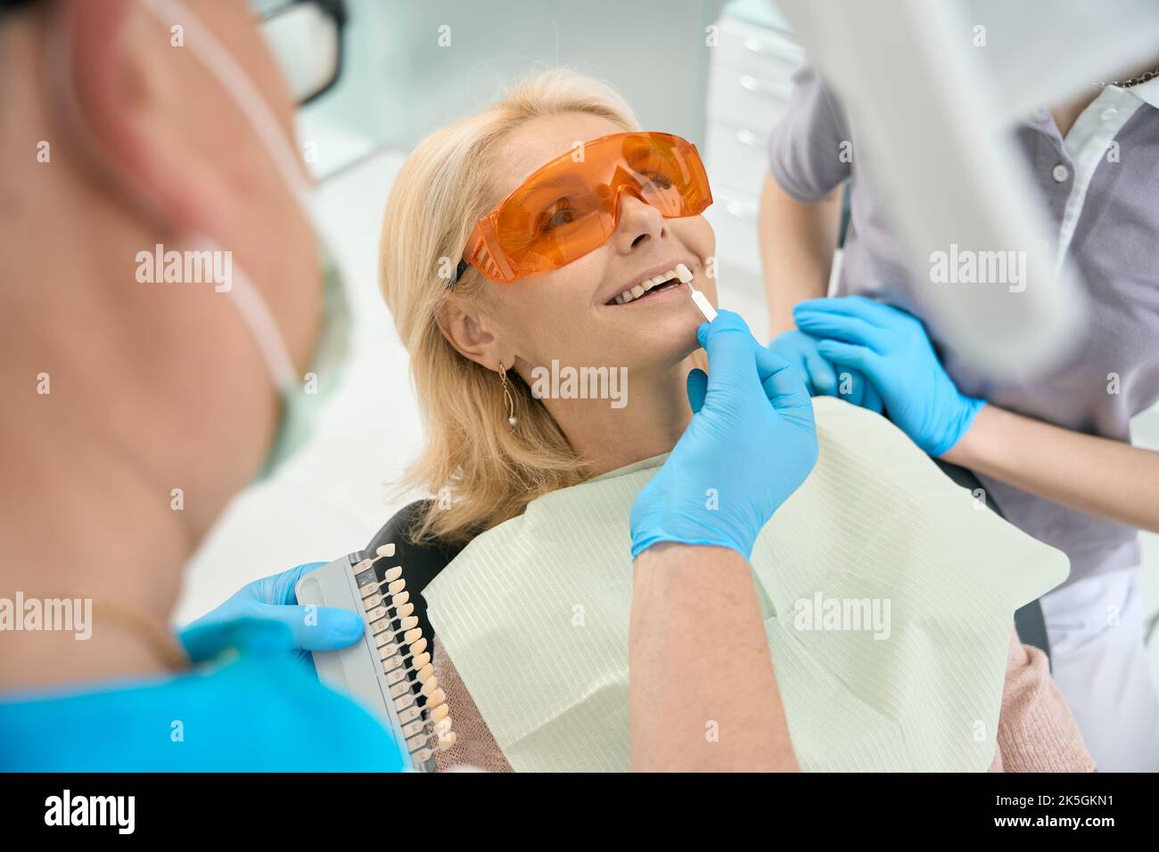 Beautiful female is doing professional vinyl teeth in stomatology ...