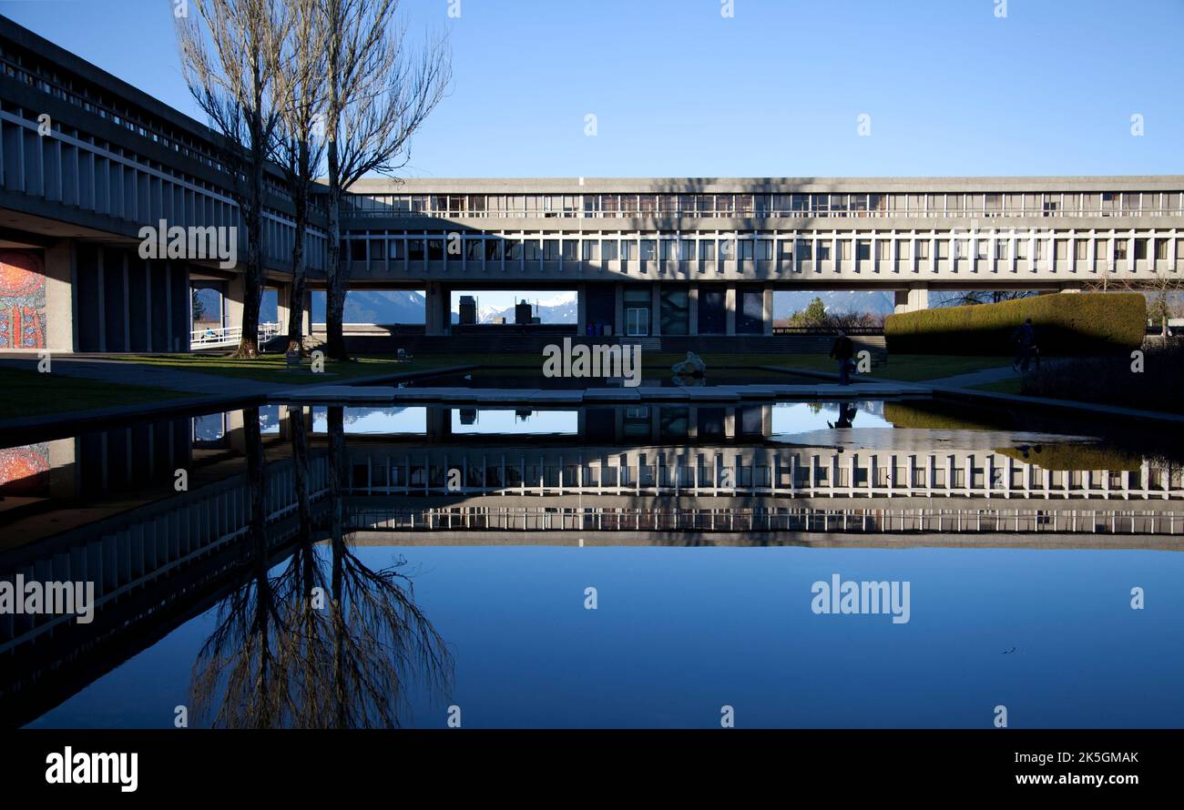 A modern bridge building reflected on the water surface. Simon Fraser ...