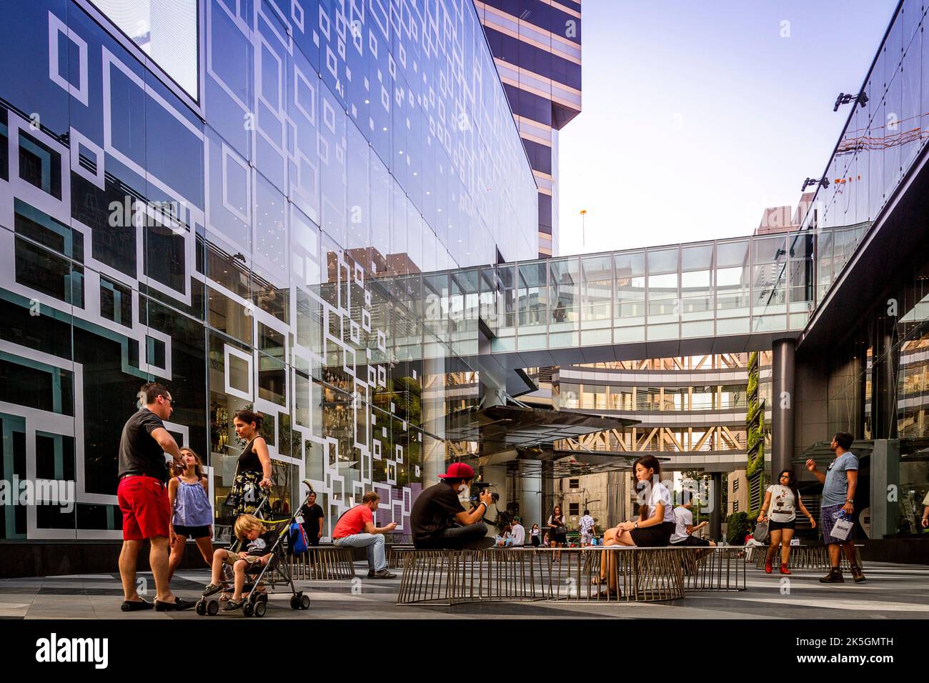 People are relaxing outside of the Paragon shopping mall in Bangkok ...