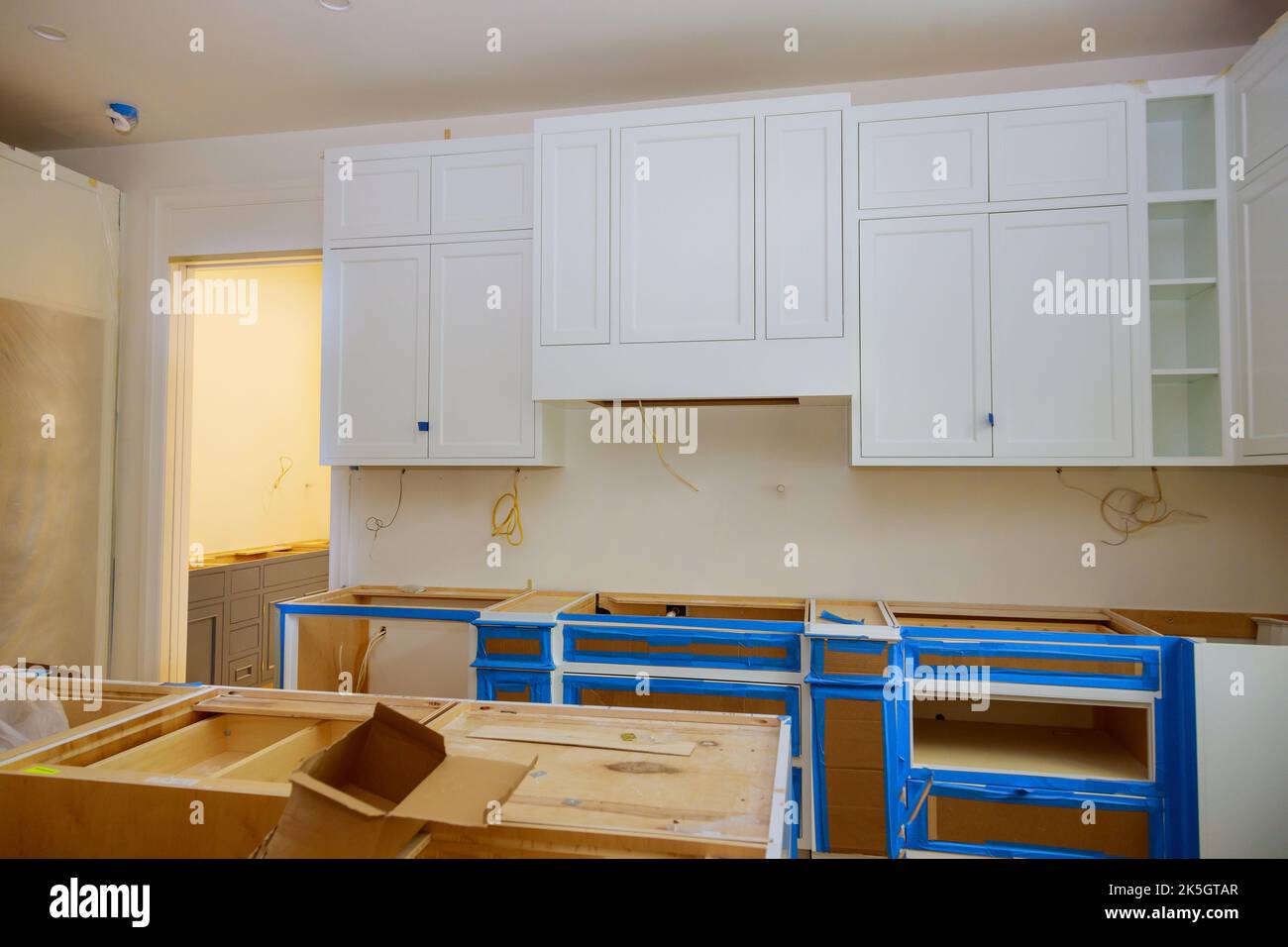 In newly constructed house, white kitchen cabinets and furniture were ...