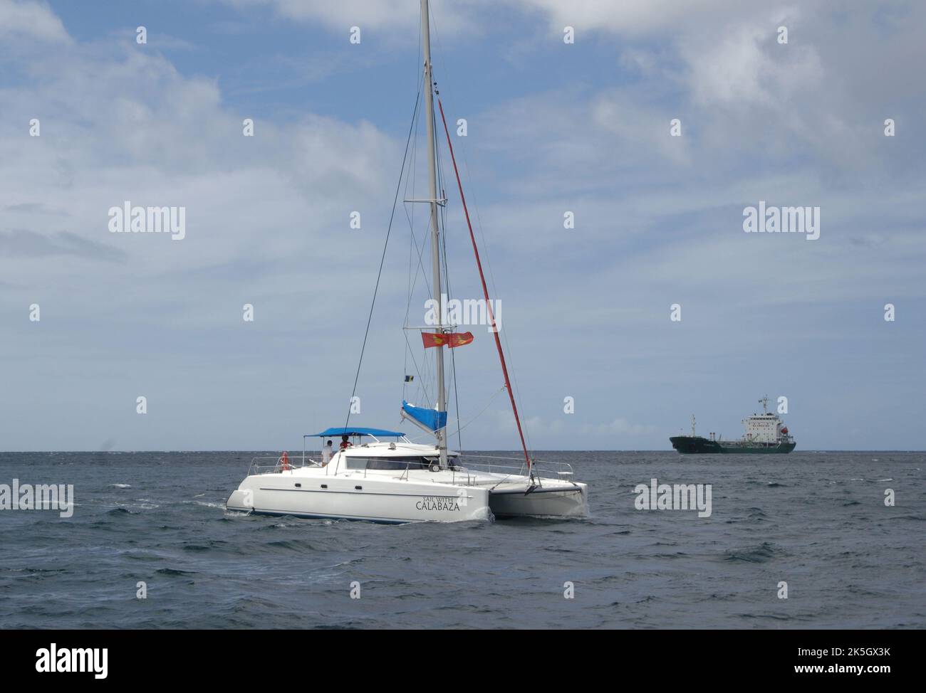 A Catamaran and a Cargo Ship off the Coast of Barbados in the Caribbean ...