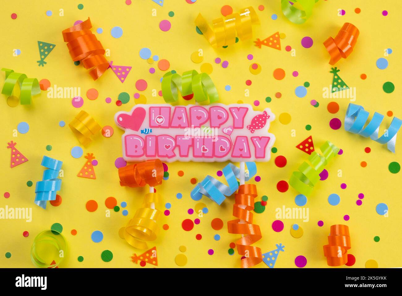 yellow background with confetti, serpentine for birthday or party ...