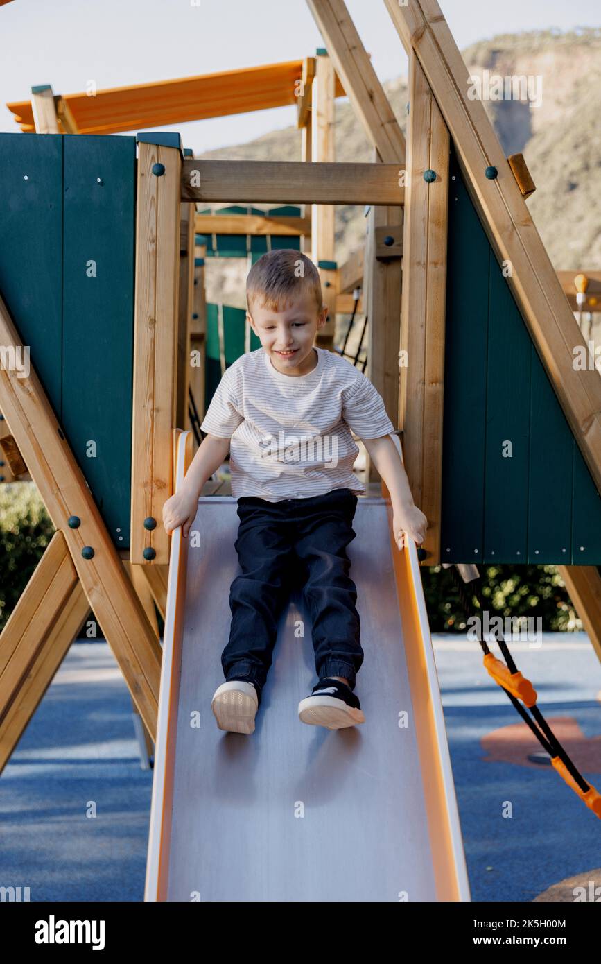 Child going down playground slide hi-res stock photography and images ...