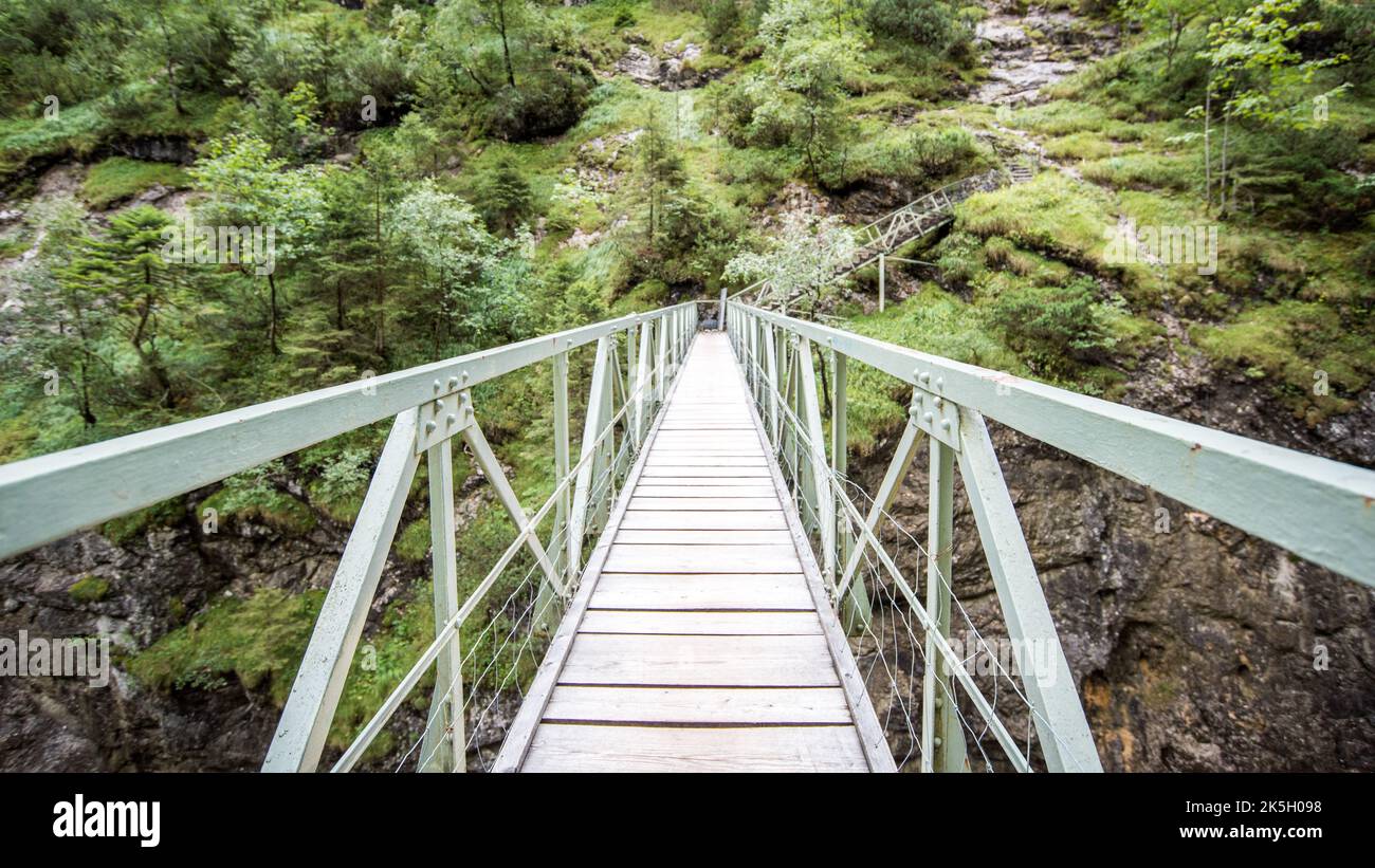 A long white bridge on a green mountain Stock Photo - Alamy