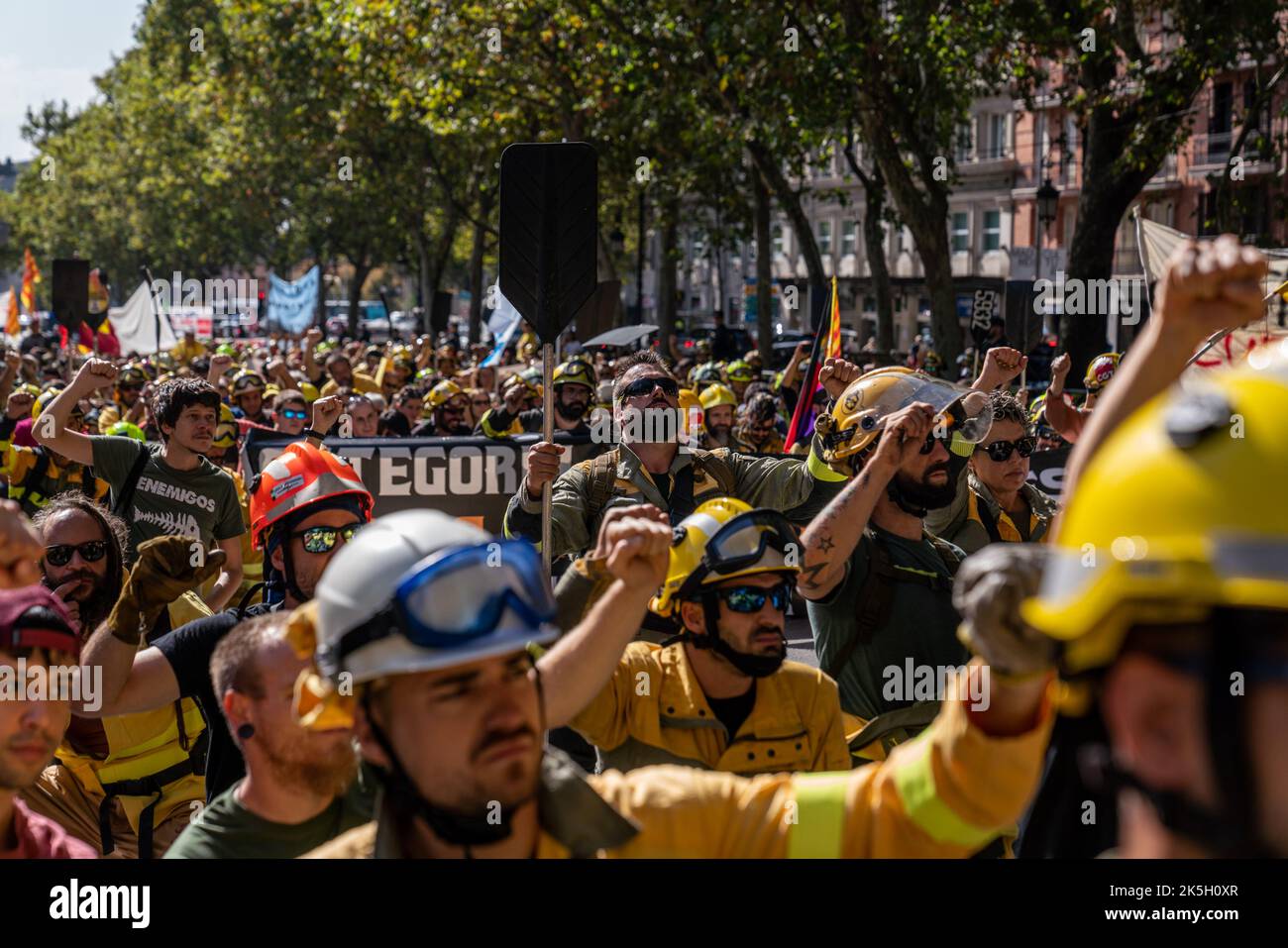 Firefighters seen raising their fists during the protest. Firefighters ...