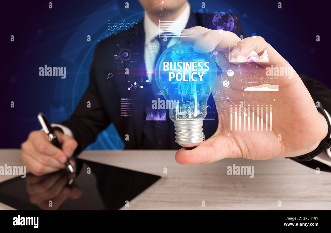 Businessman holding a light bulb, new business concept Stock Photo - Alamy