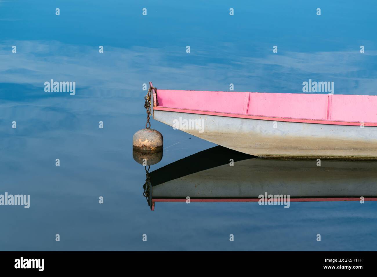 Boat bow isolated in blue water, reflection in still water Stock Photo ...