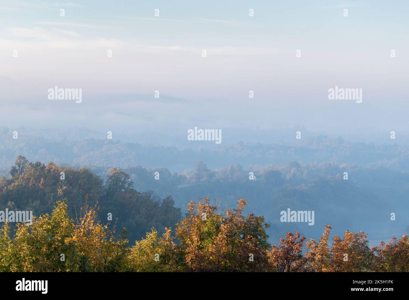 Hilly village in morning fog during autumn, airy rural landscape Stock ...