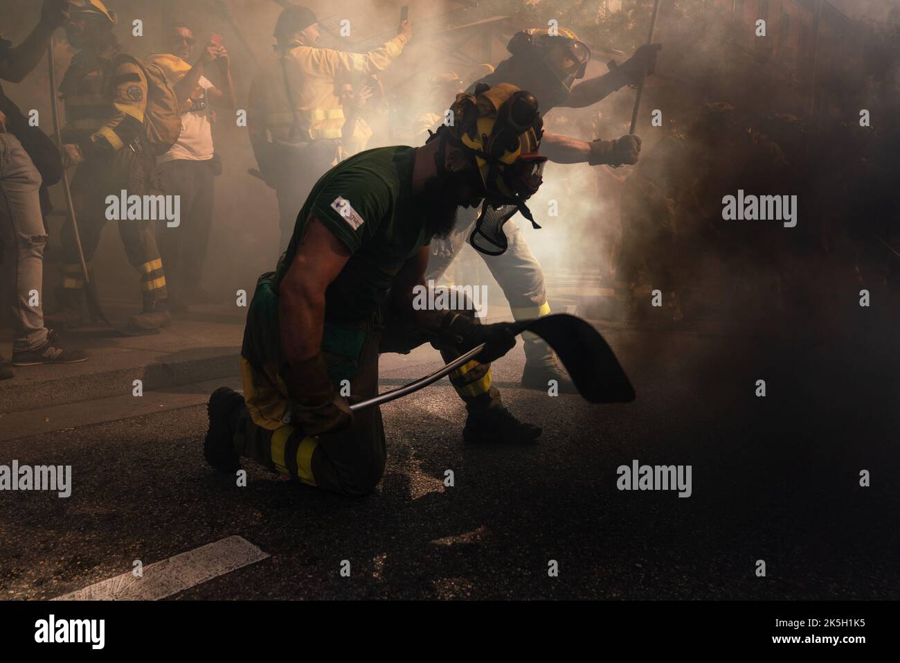 Madrid, Spain. 08th Oct, 2022. A firefighter hits the ground with a ...