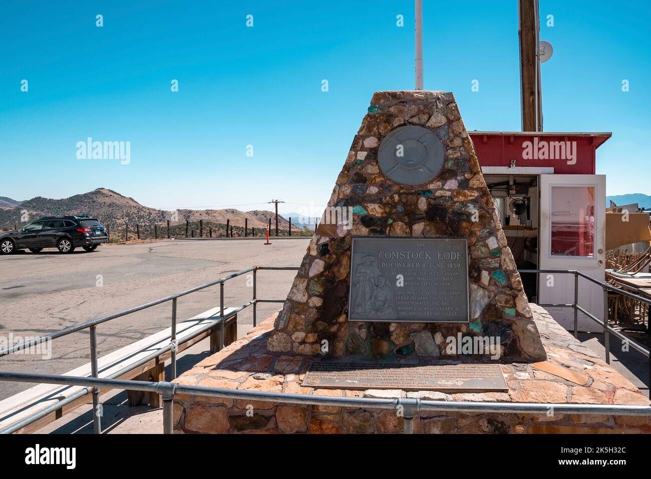 Sign on memorial structure by road in vintage city with blue sky in ...