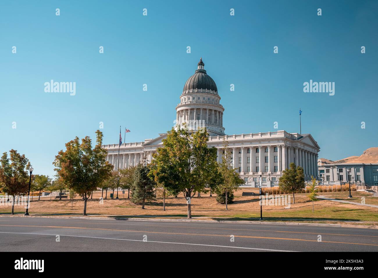 Empty road by State Capitol building with clear blue sky in background ...