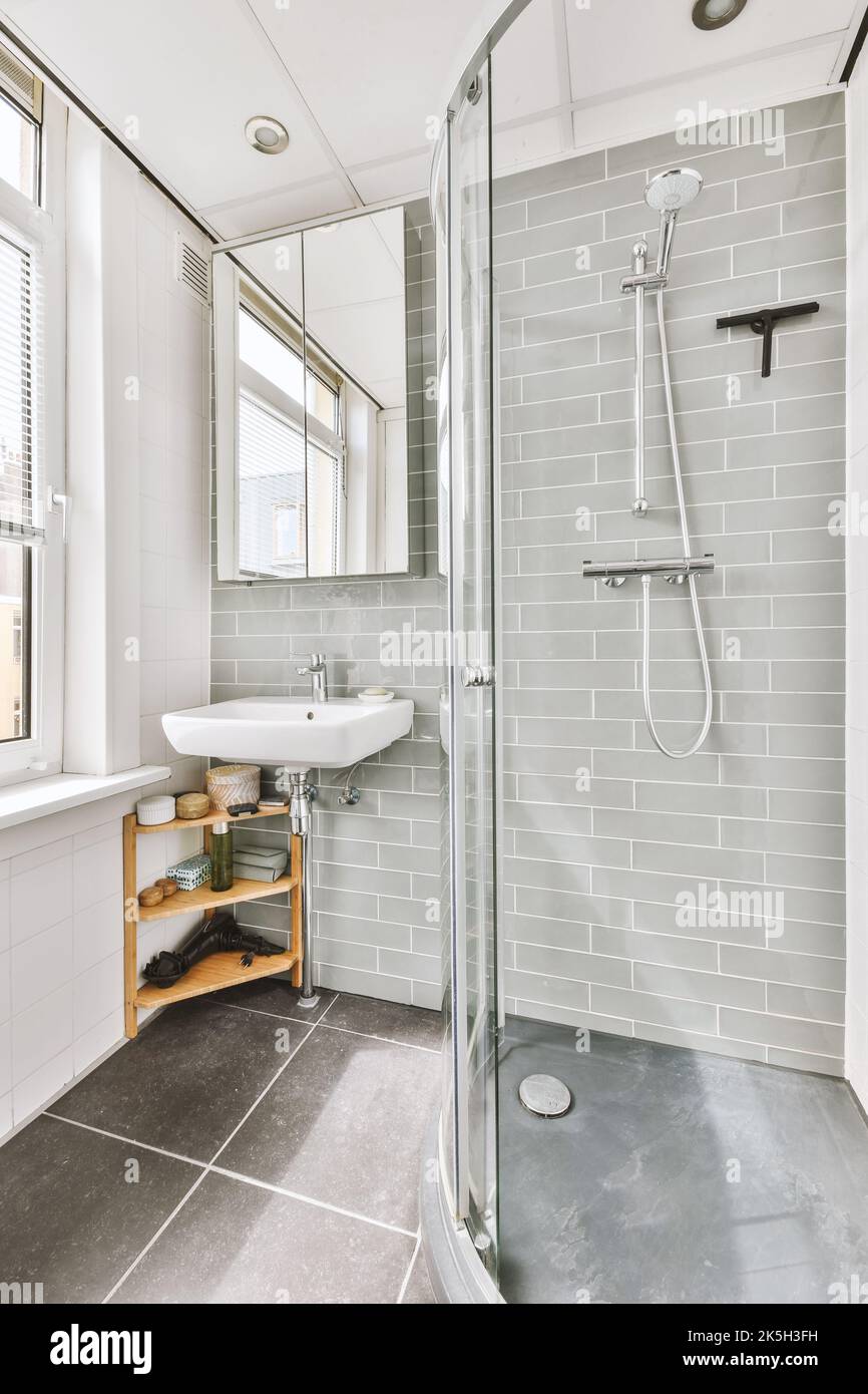 Sinks with mirrors and shower box with glass door in modern bathroom ...