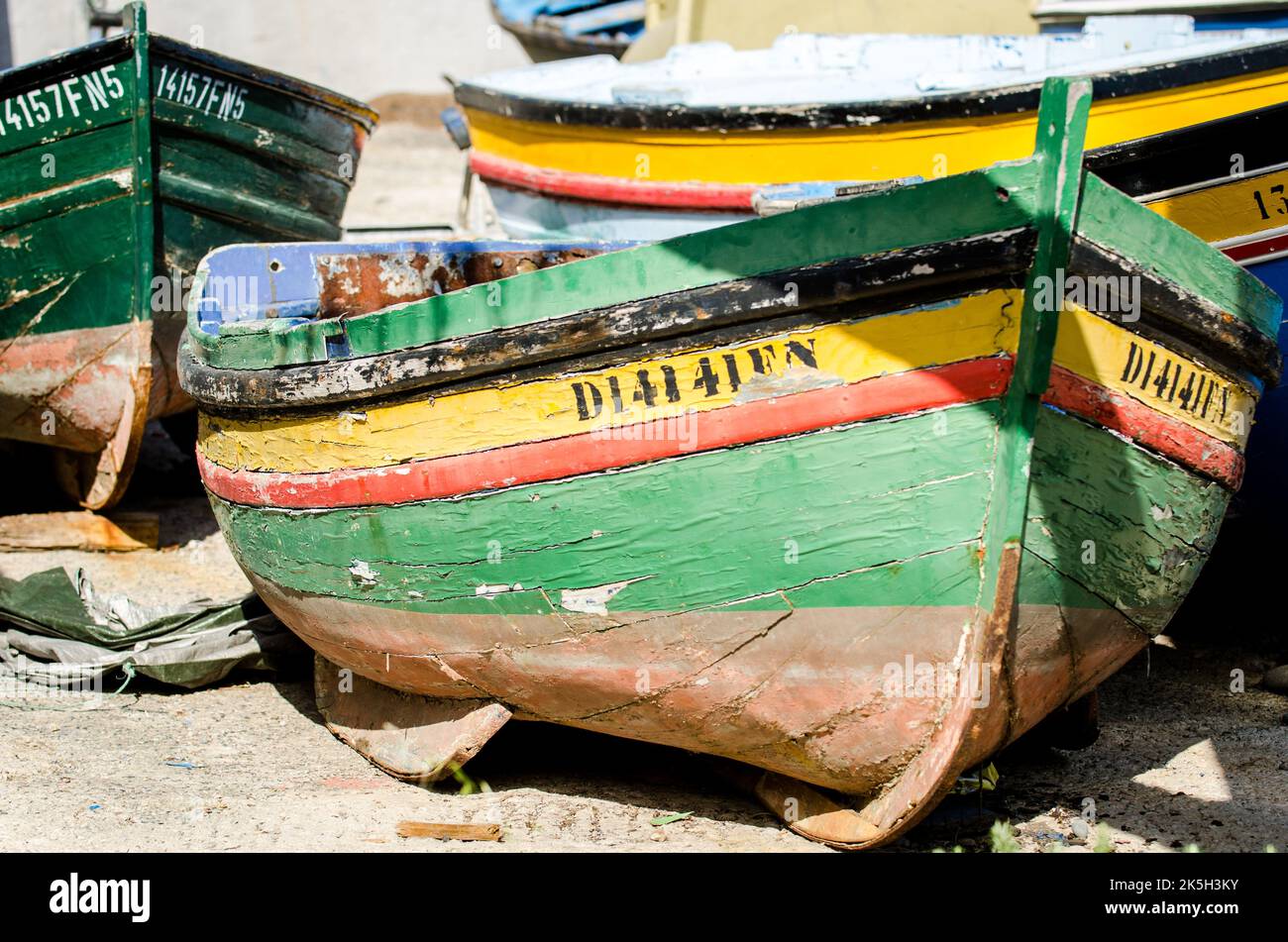 An old colorful wooden boat on a shore in sunny weather Stock Photo - Alamy