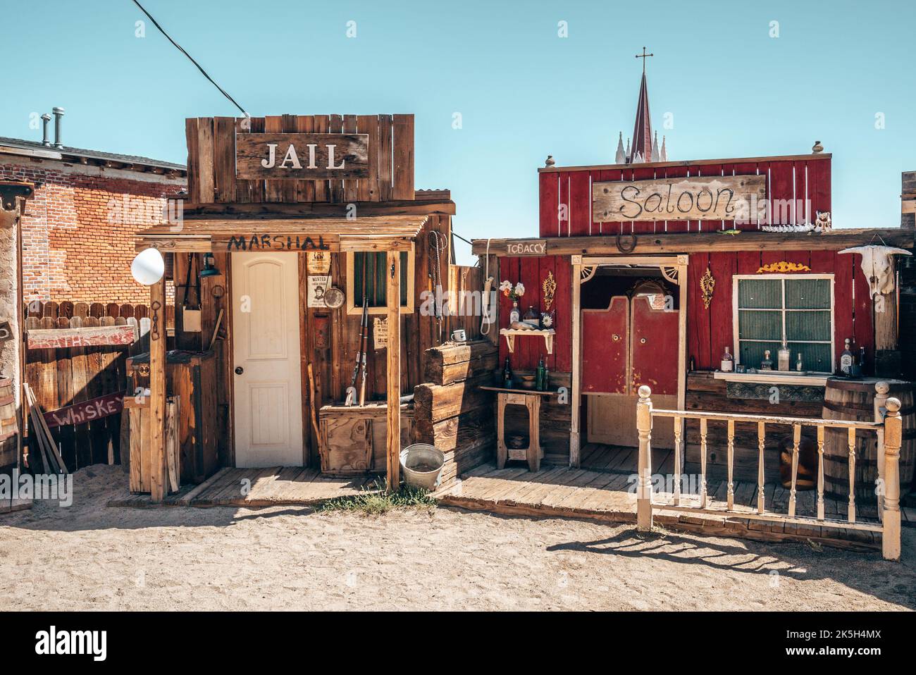 Vintage shop and jail in historic city by road with sky in background ...