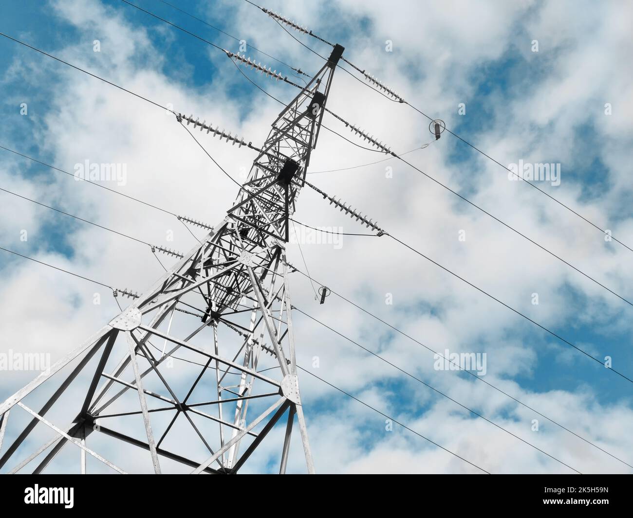 Tower of Electrical power lines on blue cloudy sky background Stock ...