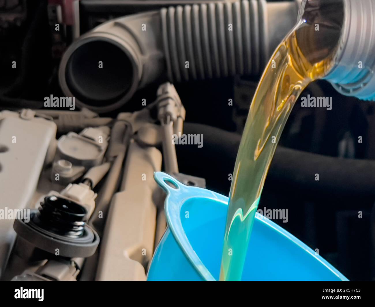 Closeup detail view of New engine oil pouring to engine Stock Photo - Alamy