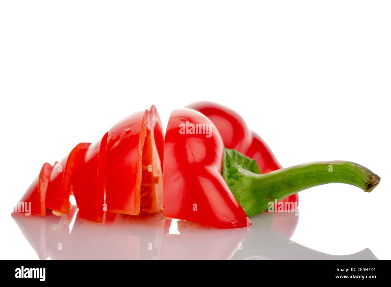 Red bell pepper cut into slices, close-up, isolated on white Stock ...