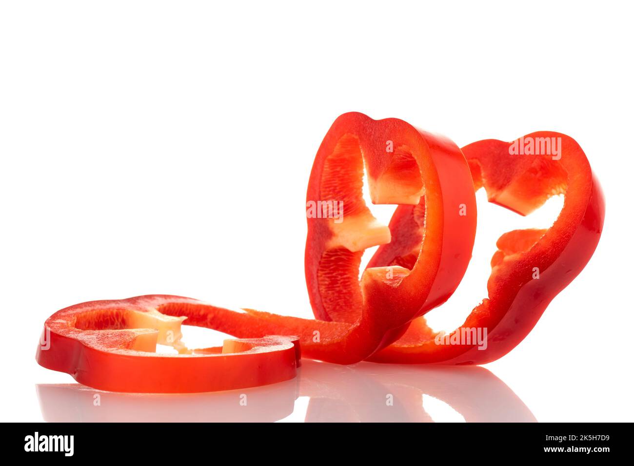 Red bell pepper cut into slices, close-up, isolated on white Stock ...