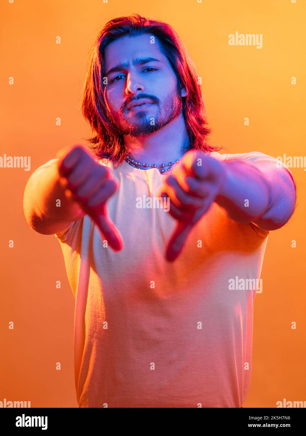 Bad choice. Disappointed man. Neon light portrait. Dislike gesture ...