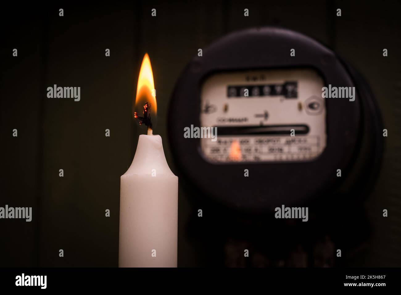 Checking old retro electric meter with candle light. Selective focus on ...