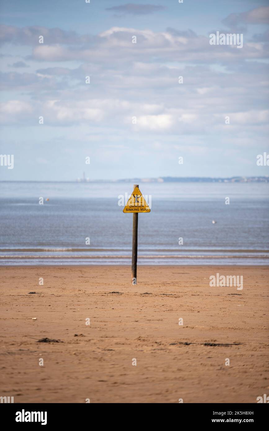 Sinking sand warning sign on sandy beach Stock Photo - Alamy