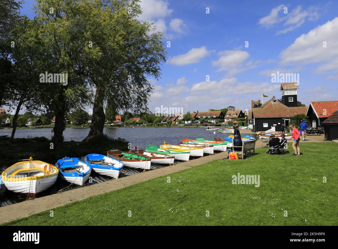 Colourful wooden rowing boats on the Mere at Thorpeness village ...