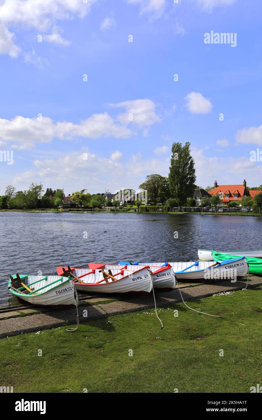 Colourful wooden rowing boats on the Mere at Thorpeness village ...