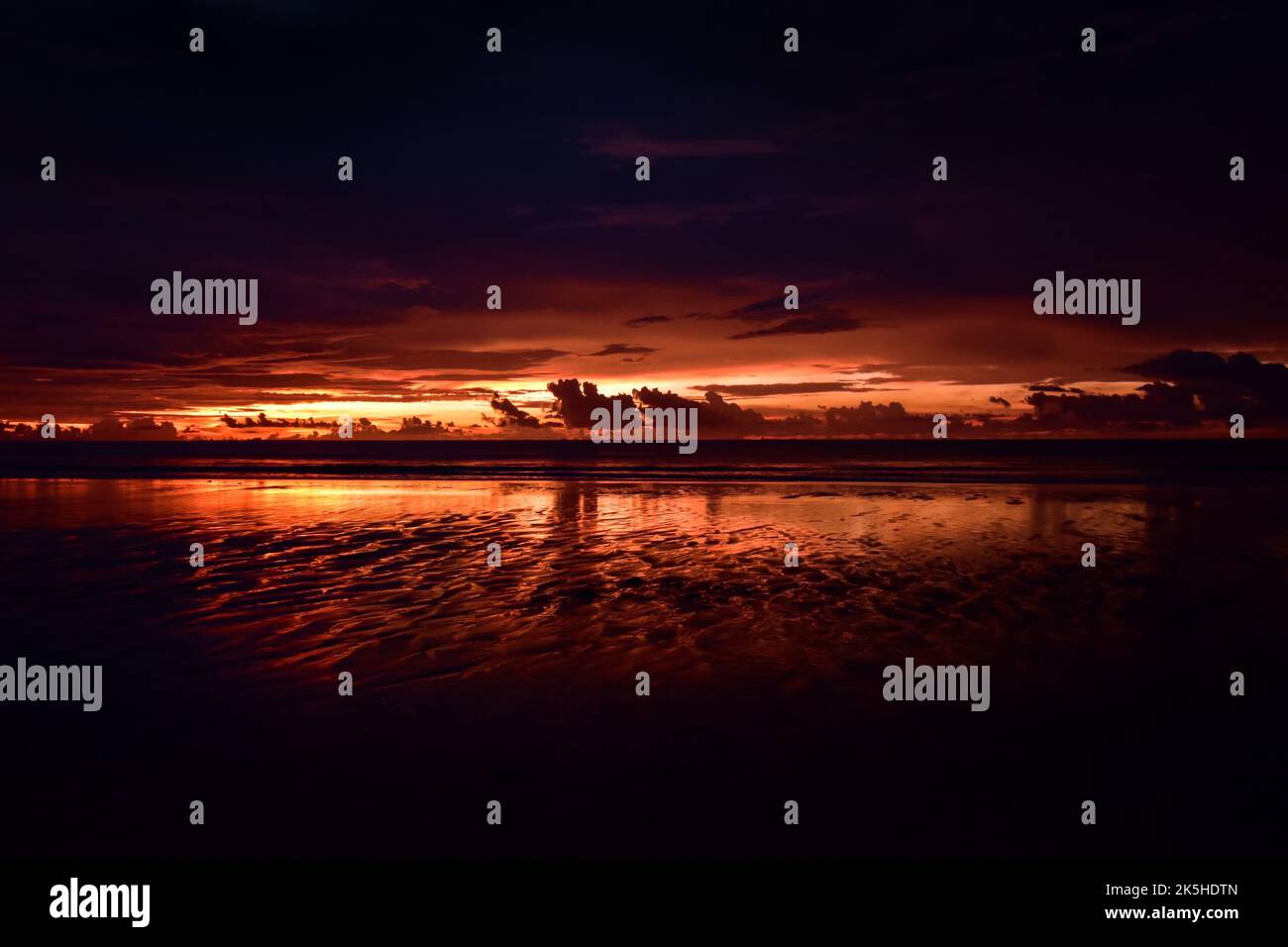Landscape scene of sunset at Chaung Tha beach. Cloudy sky. Ending hour ...