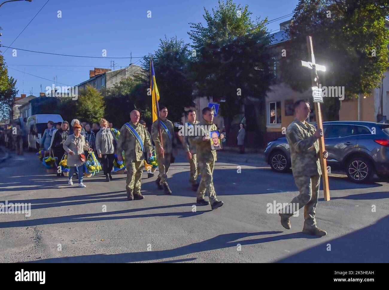 A funeral procession passes through the streets of the city of Sambir ...