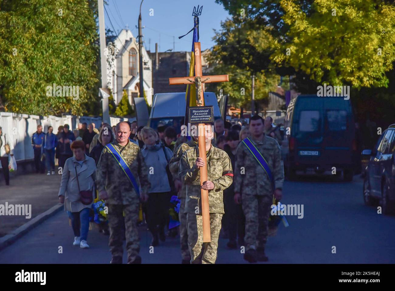 A funeral procession passes through the streets of the city of Sambir ...