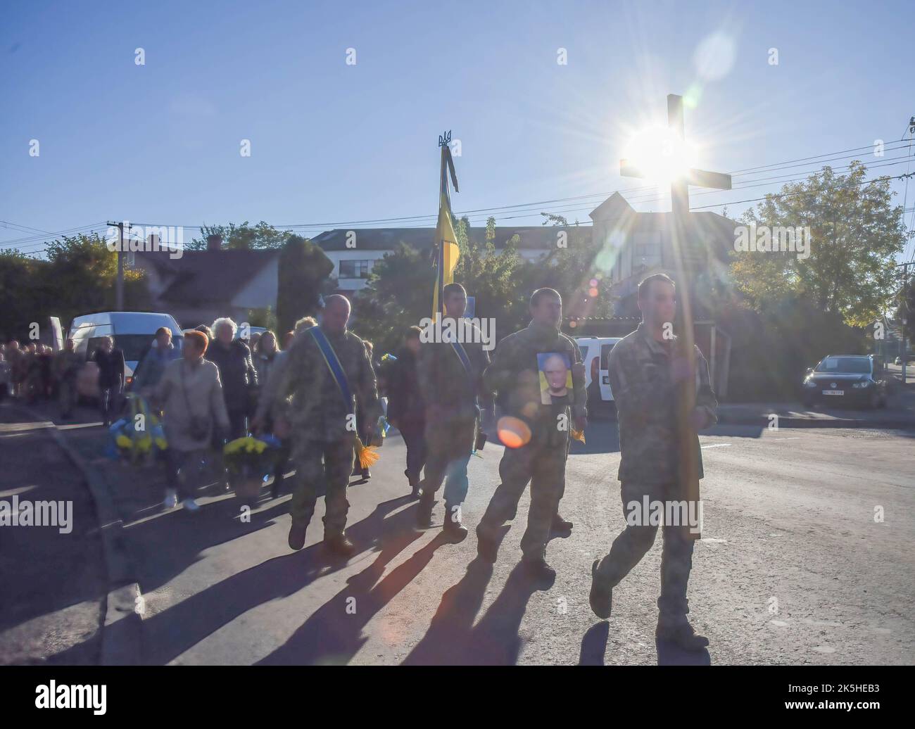 A funeral procession passes through the streets of the city of Sambir ...