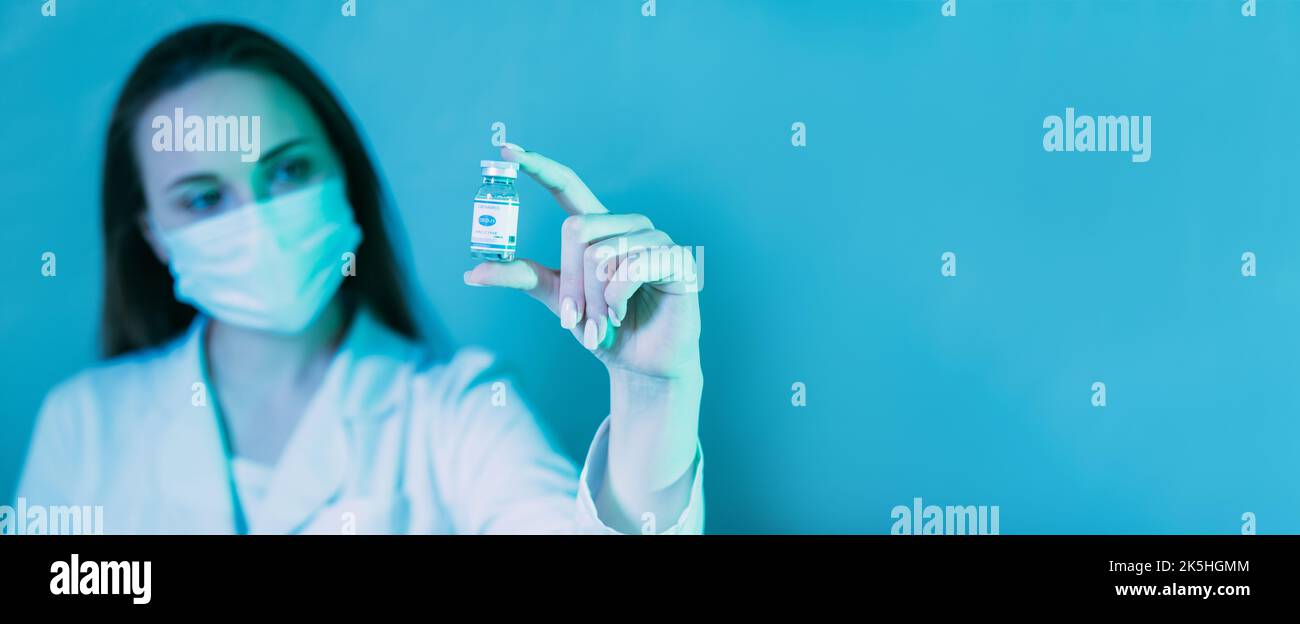 covid-19 vaccine pandemic banner doctor vial dose Stock Photo - Alamy