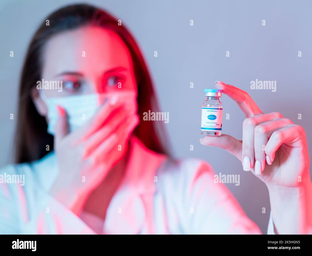 vaccine danger covid-19 shocked doctor vial dose Stock Photo - Alamy