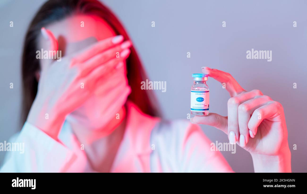 vaccination risk coronavirus scared doctor vial Stock Photo - Alamy