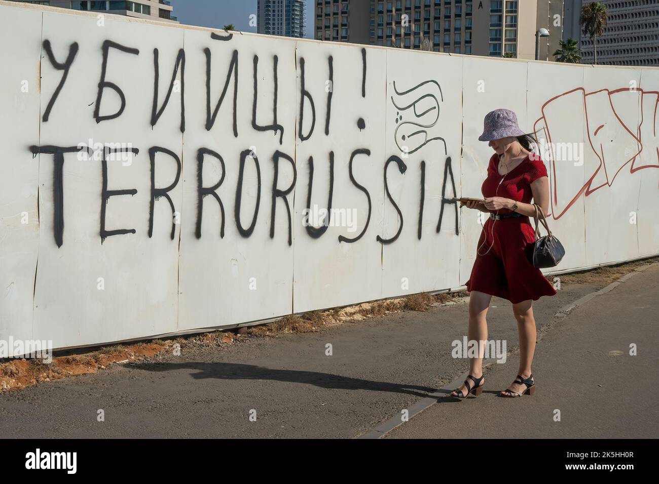 Tel Aviv, Israel - September 15th, 2022: A woman walking past an anti ...