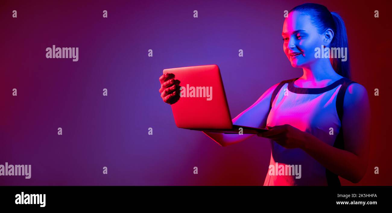 digital communication neon banner woman laptop Stock Photo - Alamy