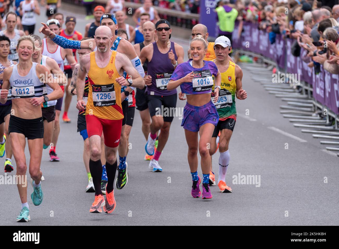 Club runners running in the TCS London Marathon 2022 road race in Tower ...