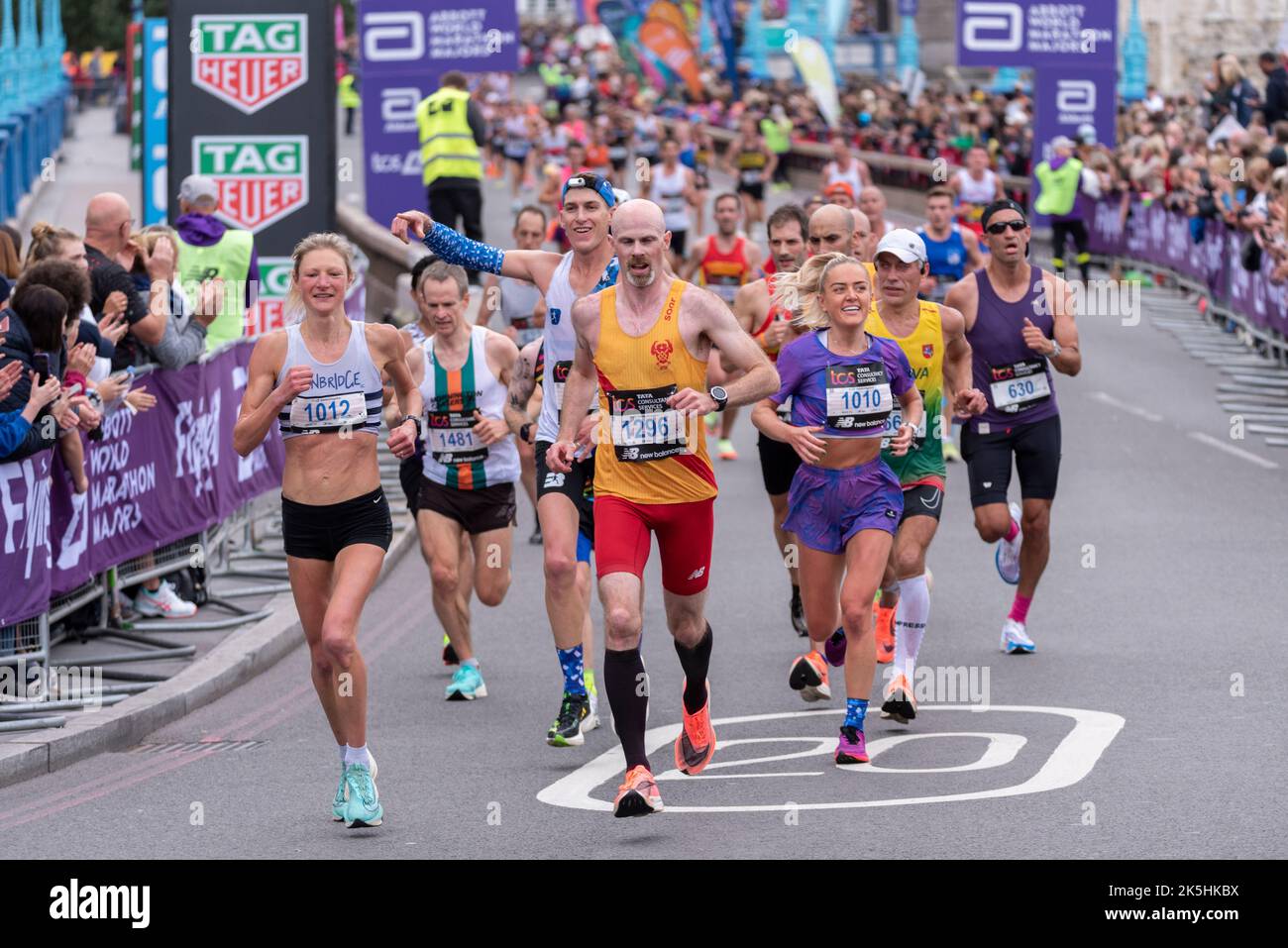 Club runners running in the TCS London Marathon 2022 road race in Tower ...
