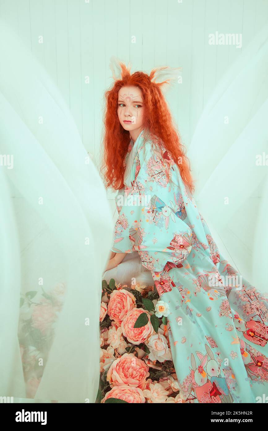 young red-haired girl with fox ears and tails. Nine tailed fox. Young ...