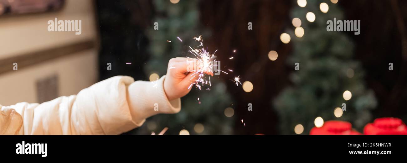 female hand holding sparkler bengal fire sticks outdoor on happy new ...