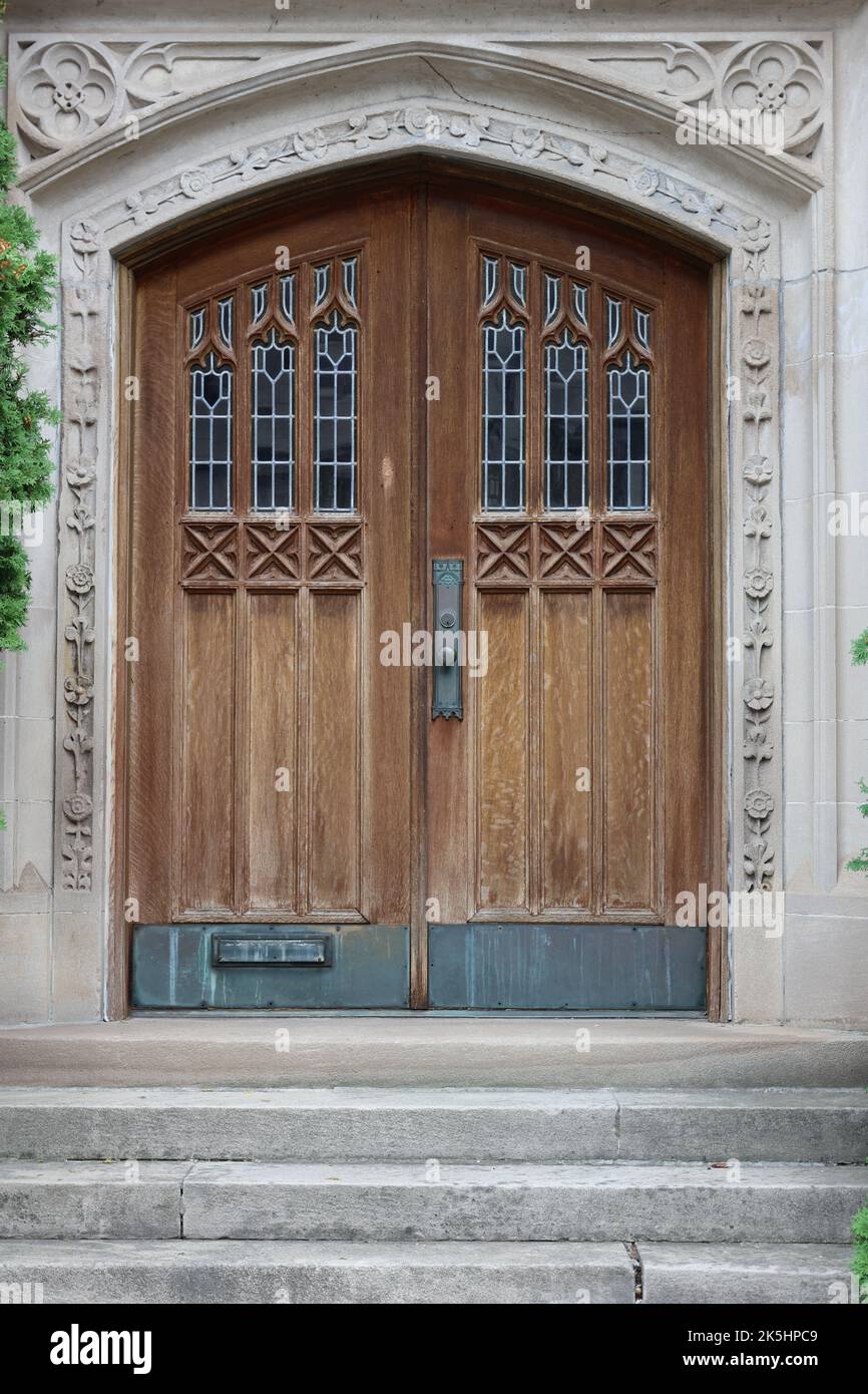 Wooden doors framed by ornate stone carvings Stock Photo - Alamy