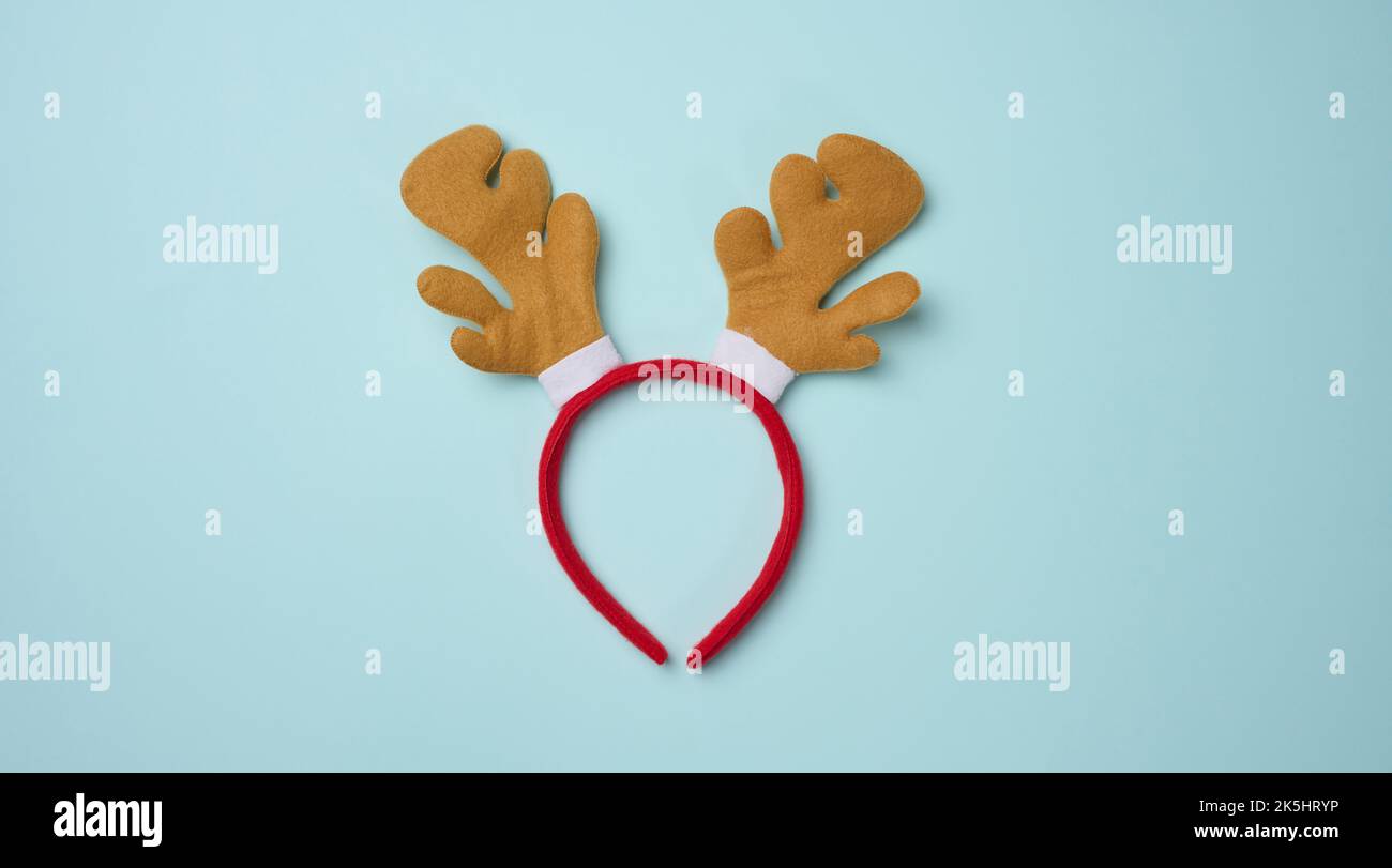 Christmas deer costume with antlers on the head on a blue background ...