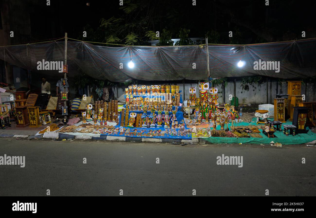 Roadside seller selling decorative items in temporary pavement stalls ...