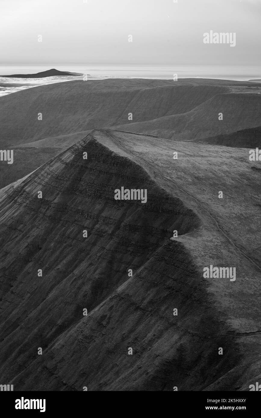 A vertical aerial shot of sandy mountains with a skyline in the ...