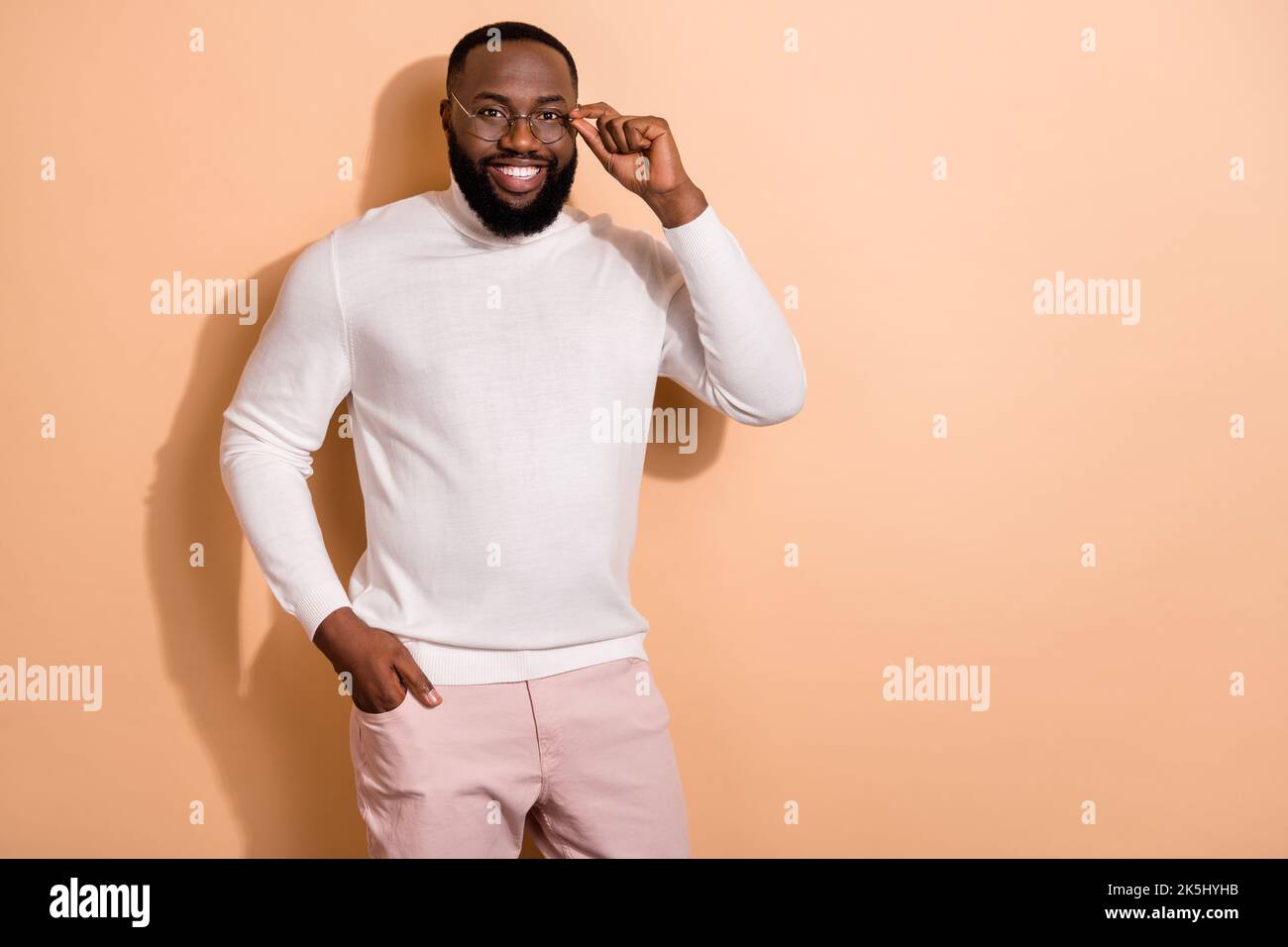 Photo of charismatic guy worker stand empty space touch specs try new ...