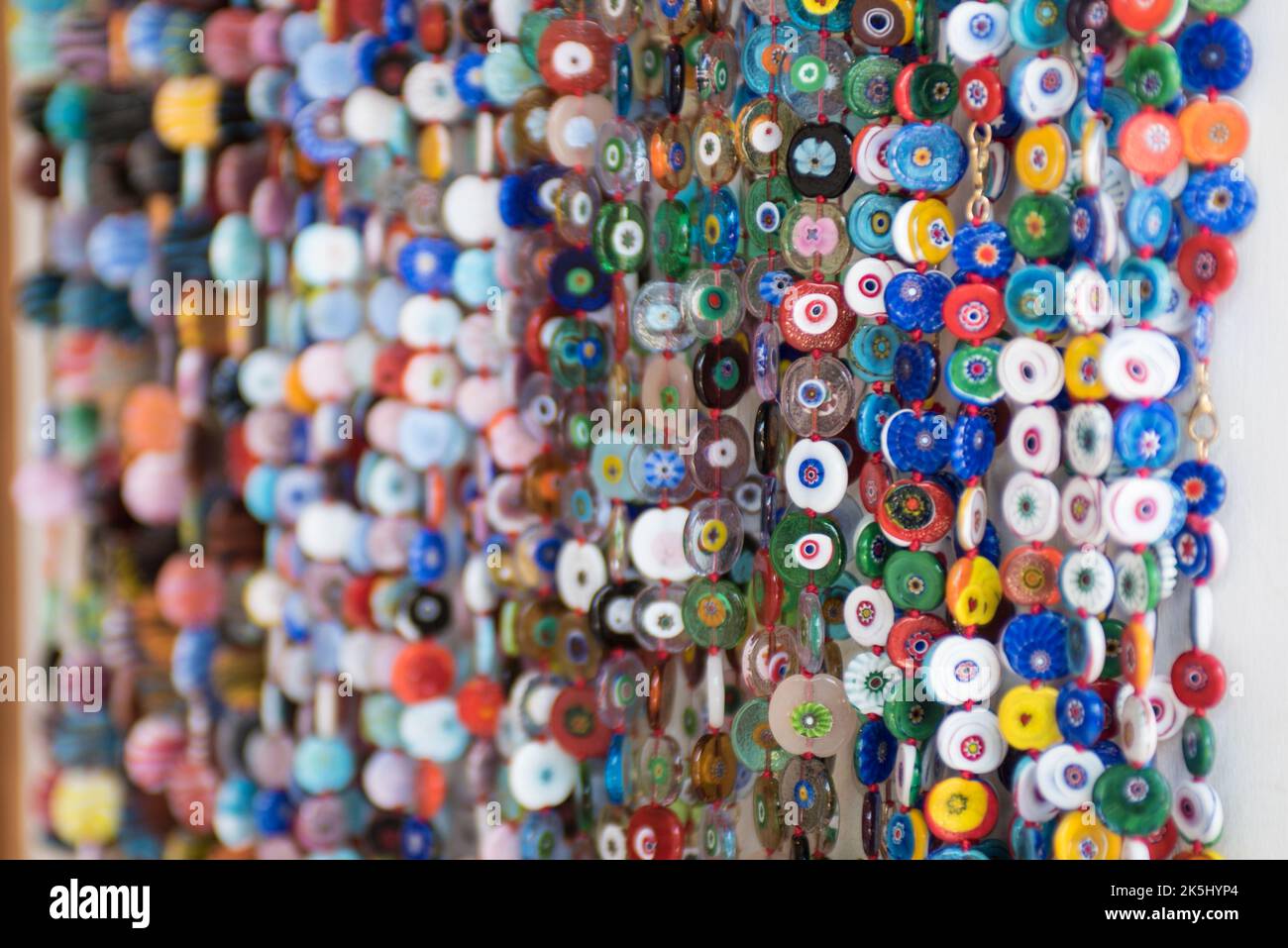 Colorful evil eye souvenirs hanging against a white wall Stock Photo ...